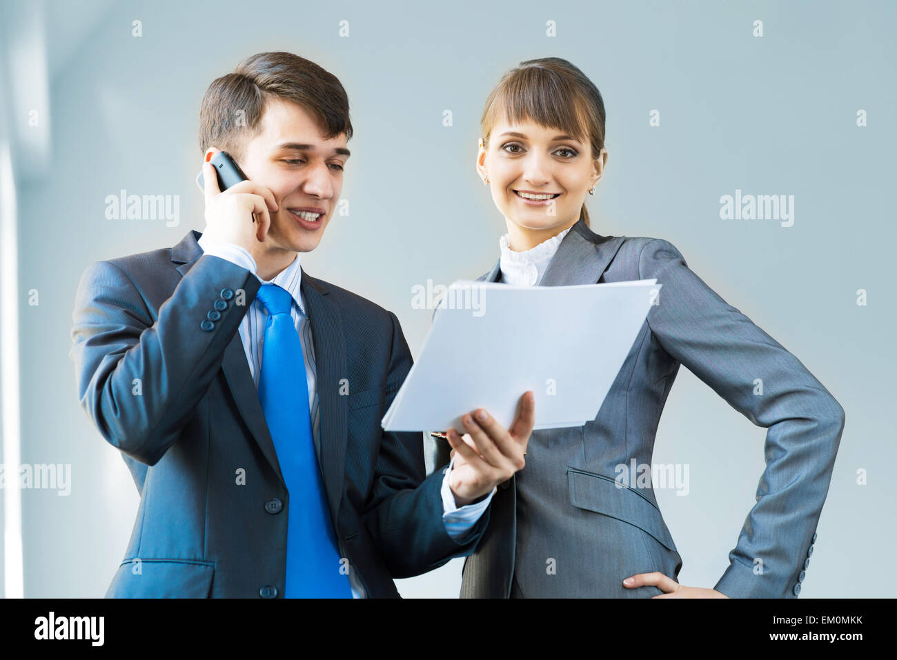 two business partners discussing reports Stock Photo - Alamy
