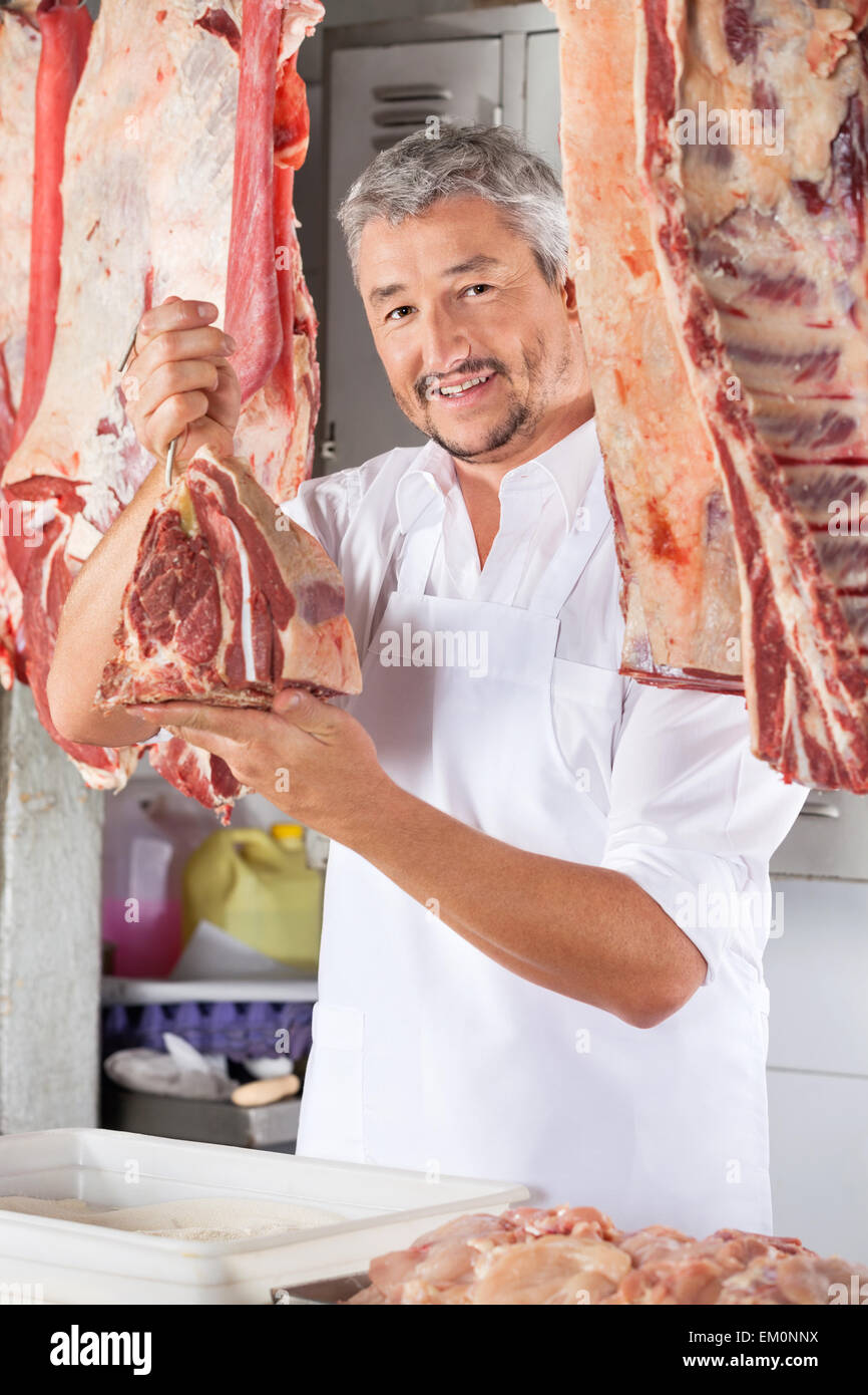 Confident Male Butcher Holding Raw Meat Stock Photo - Alamy