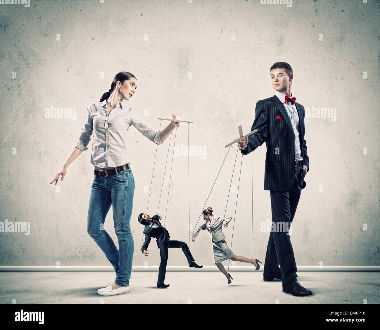 Businesspeople with marionettes Stock Photo - Alamy