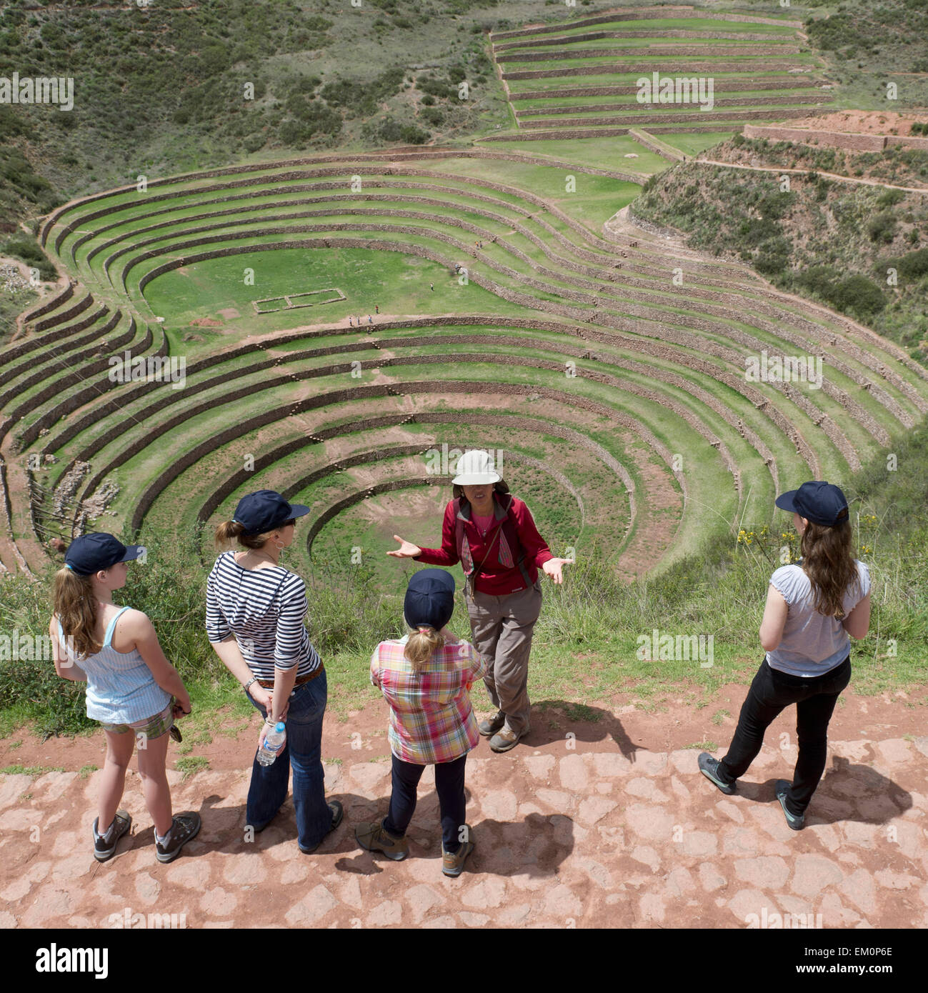 A Group Of Young Women Overlook Concentric Ring Terraces As Part Of The ...