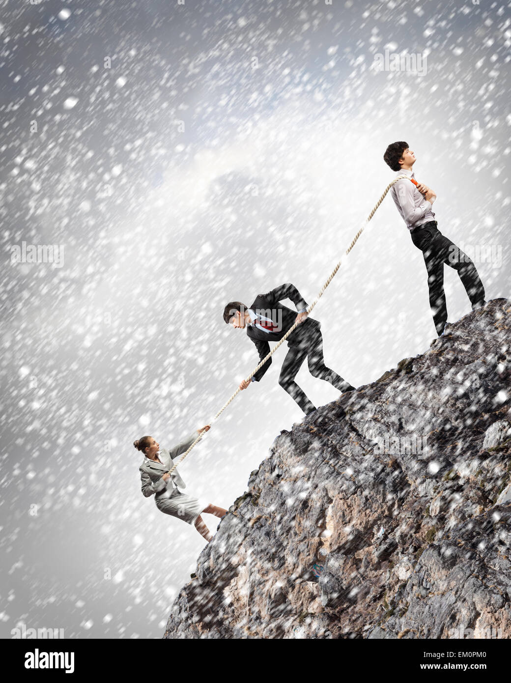 Three business people pulling rope Stock Photo - Alamy