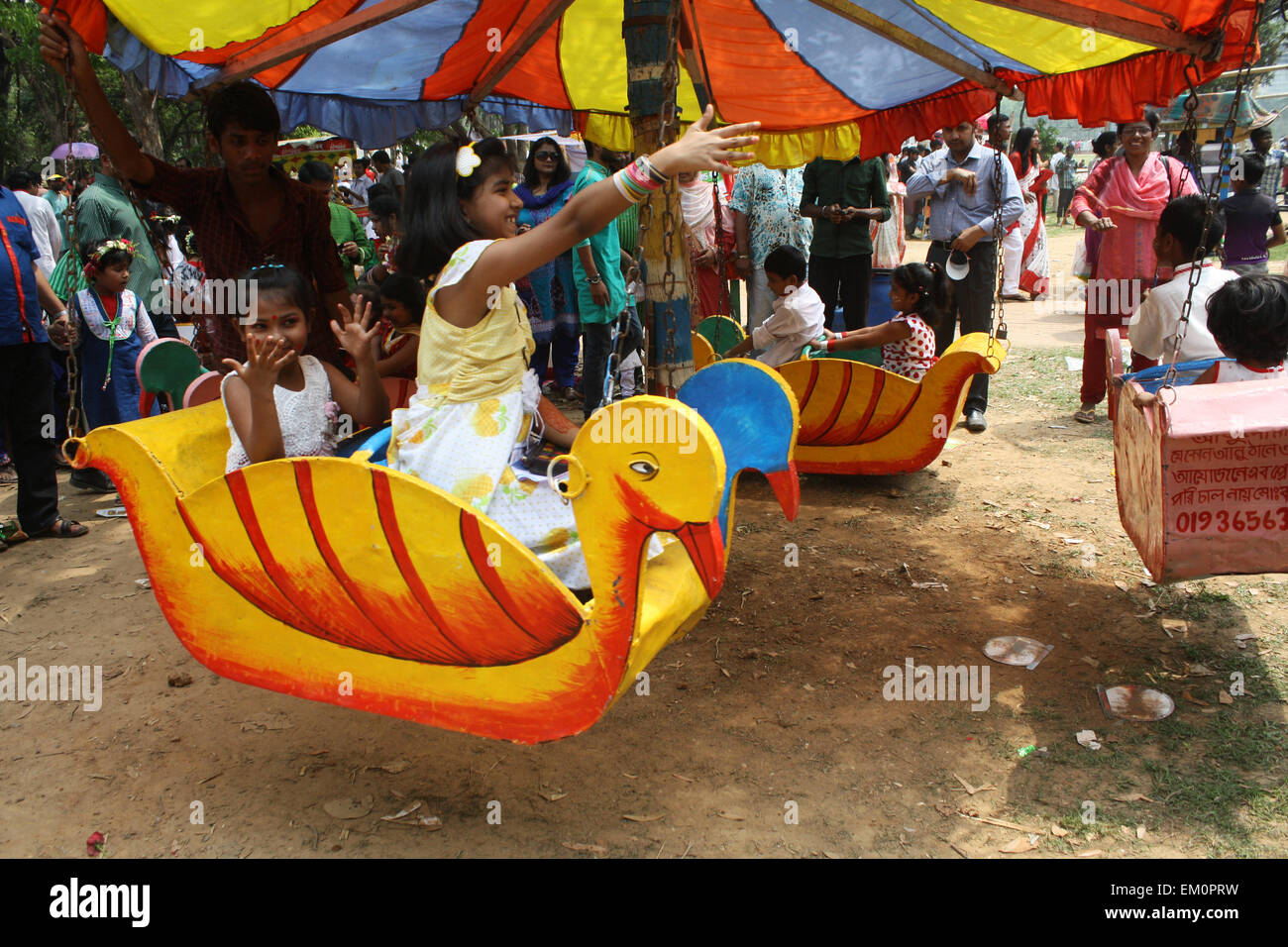 Dhaka, Bangladesh. 14th April, 2015. Bangladeshi children ride a merry ...