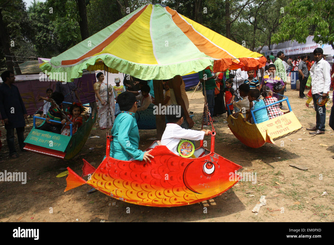 Dhaka, Bangladesh. 14th April, 2015. Bangladeshi children ride a merry ...