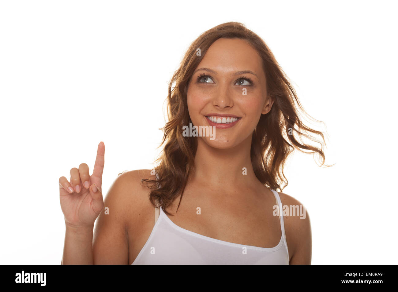 Attractive woman pointing above her head Stock Photo - Alamy