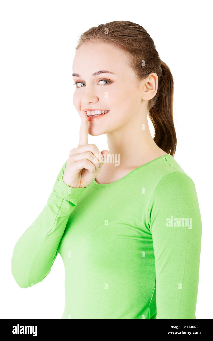 Teen girl with finger on her lips Stock Photo - Alamy
