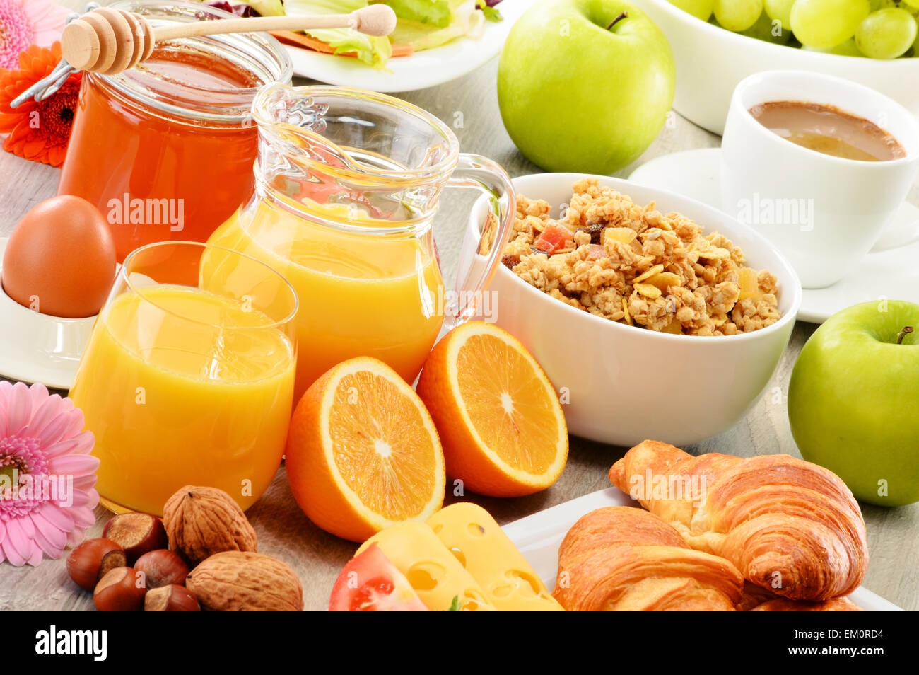 Breakfast consisting of fruits, orange juice, coffee, honey, bread and ...