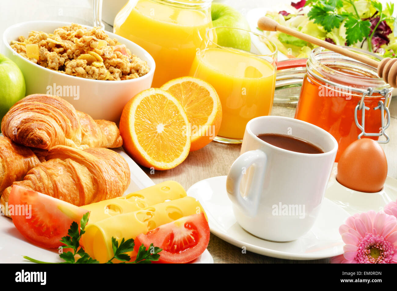 Breakfast consisting of fruits, orange juice, coffee, honey, bread and ...