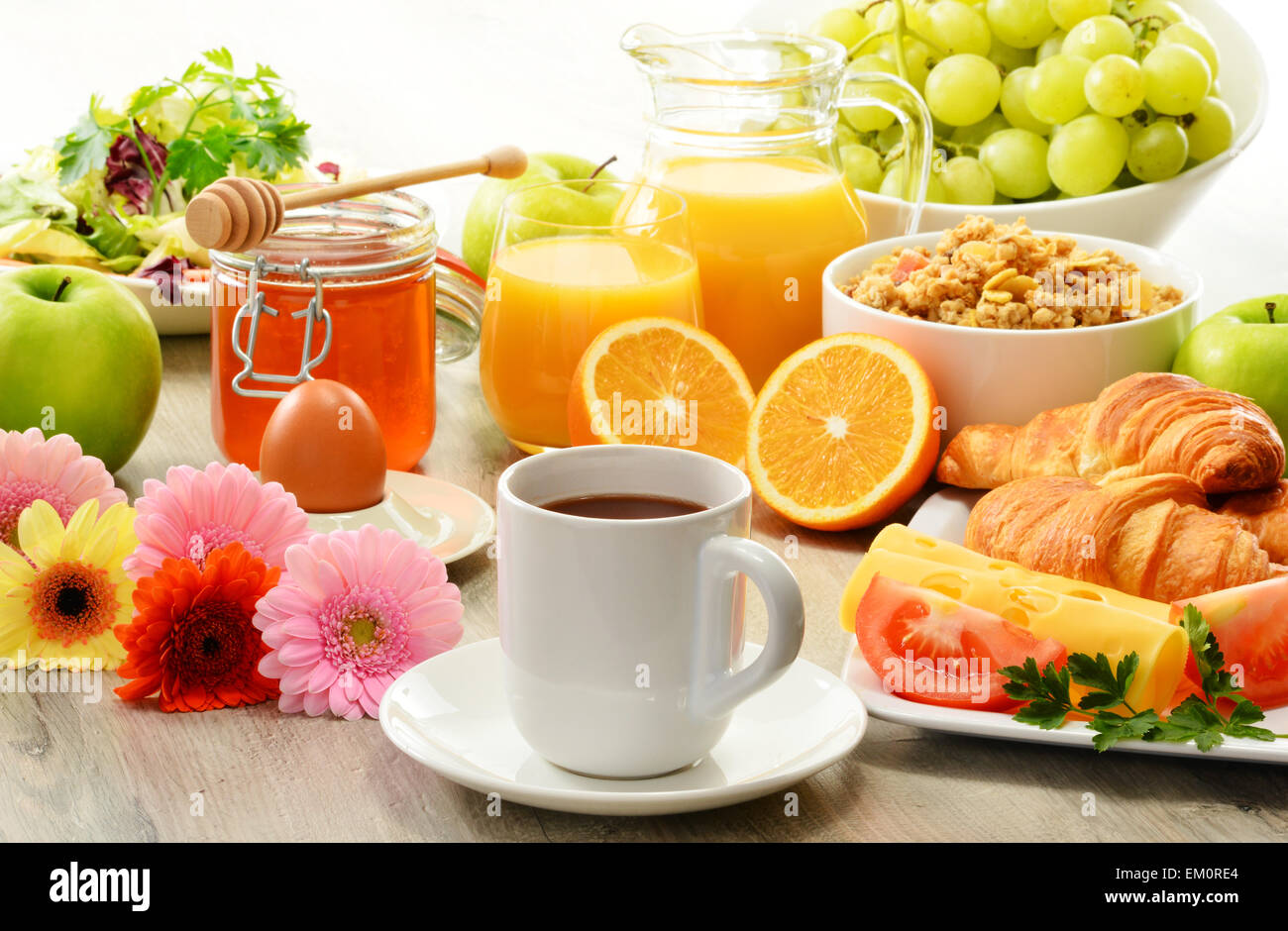 Breakfast consisting of fruits, orange juice, coffee, honey, bread and ...