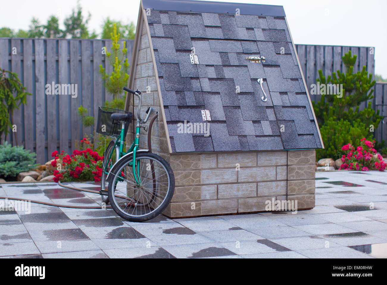 Bike next to a stone pit in the yard Stock Photo - Alamy