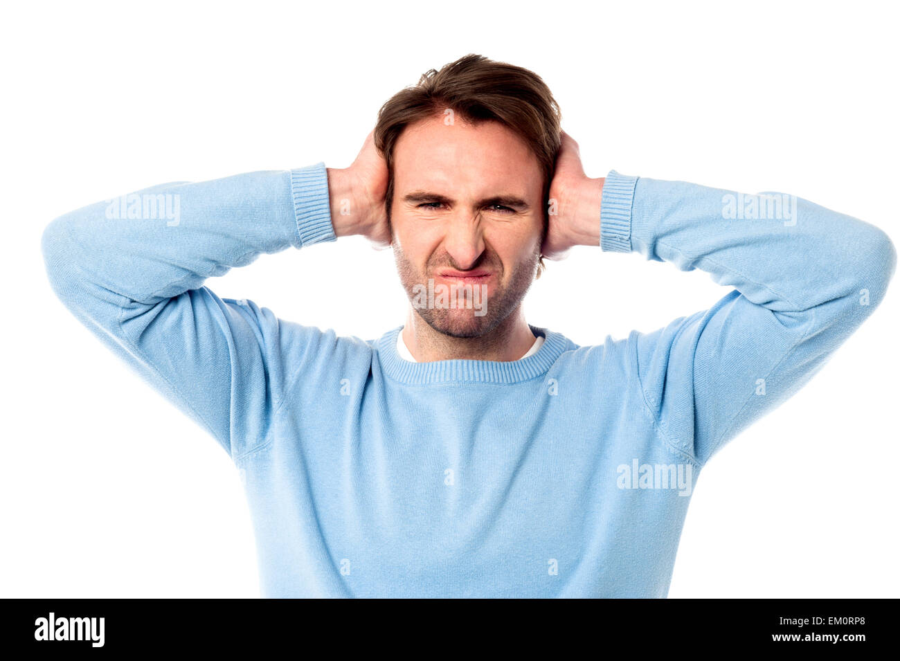 Irritated man blocking his ears Stock Photo - Alamy
