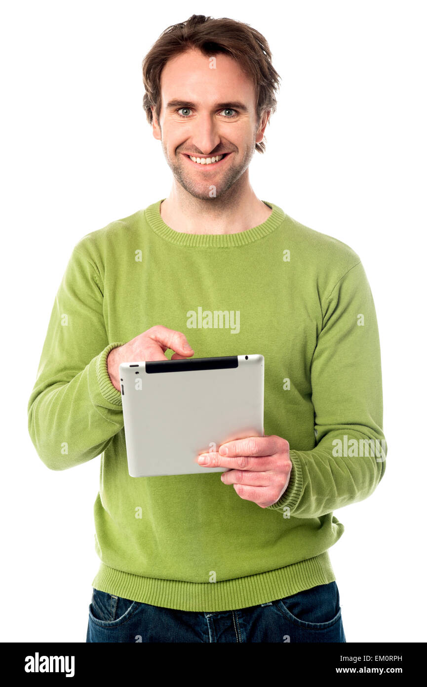 Young guy operating tablet device Stock Photo - Alamy