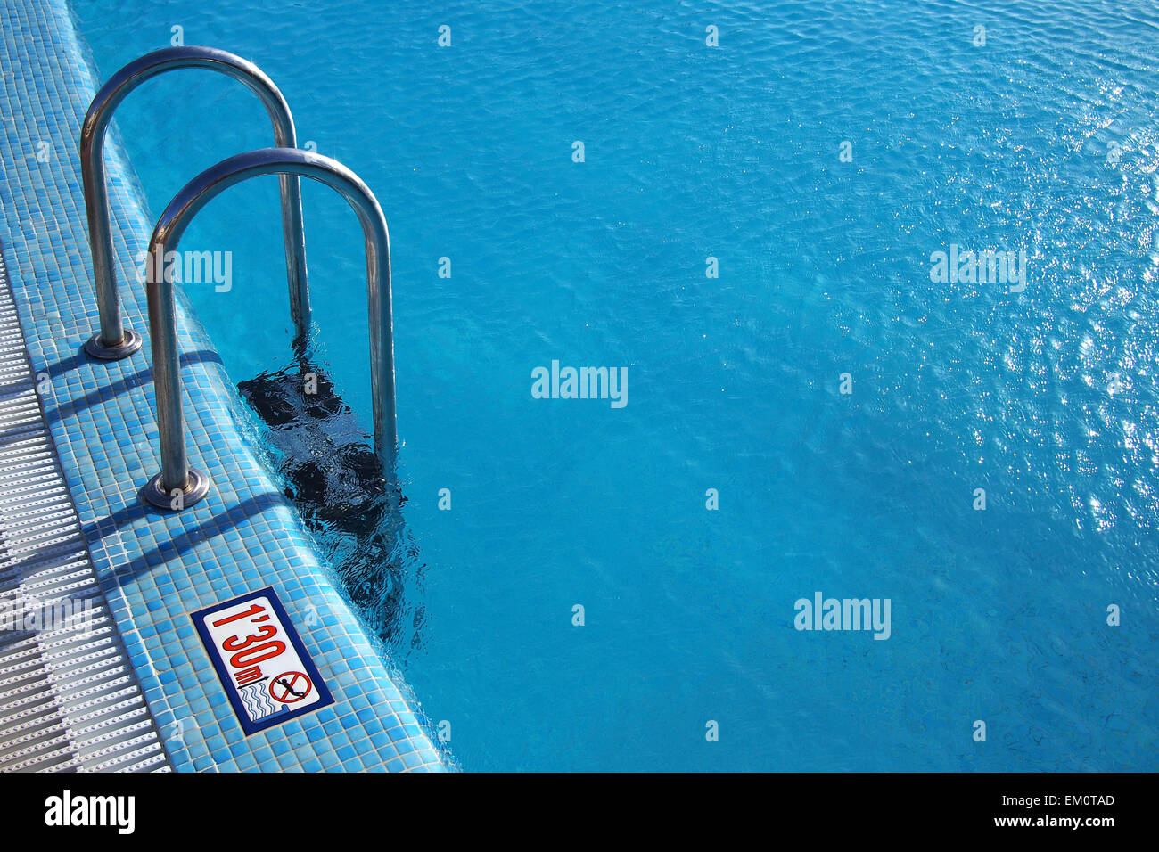 Swimming pool with steel ladder Stock Photo - Alamy