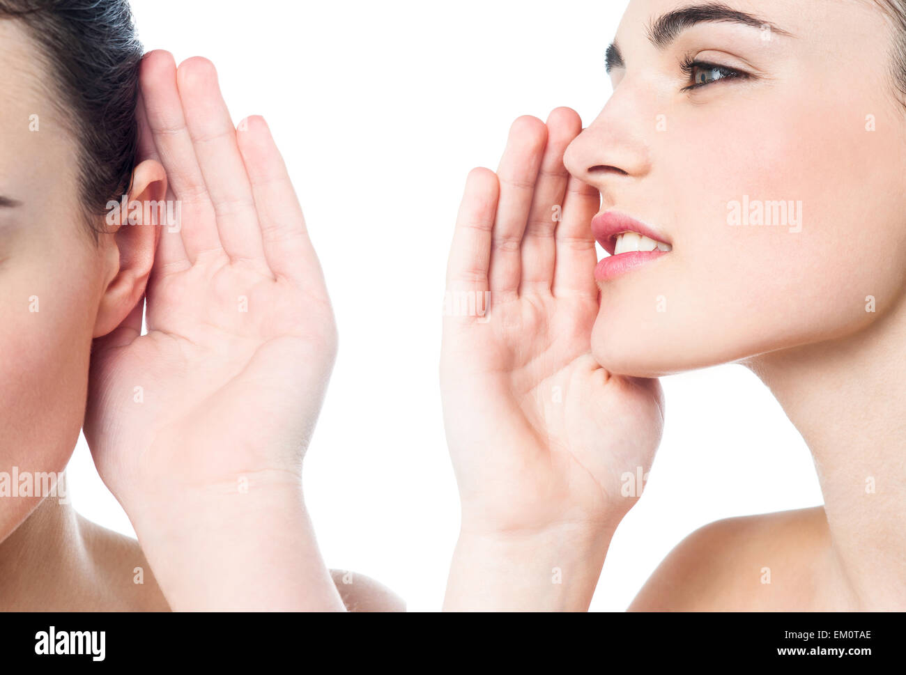 Pretty girl sharing a secret with her friend Stock Photo - Alamy