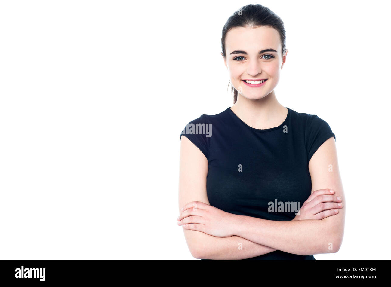 Happy young girl posing, arms crossed Stock Photo - Alamy