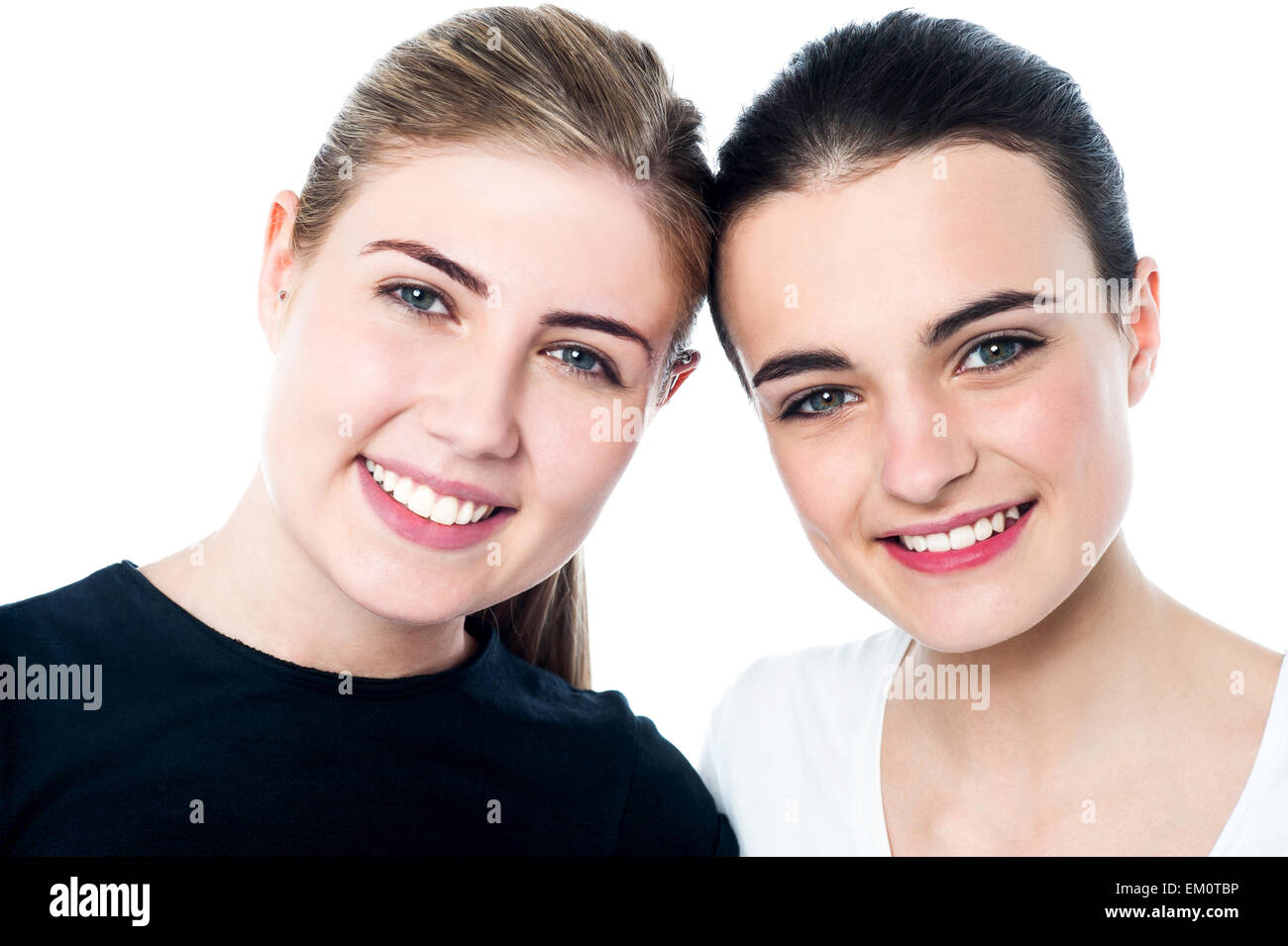 Young smiling girls looking at you Stock Photo - Alamy