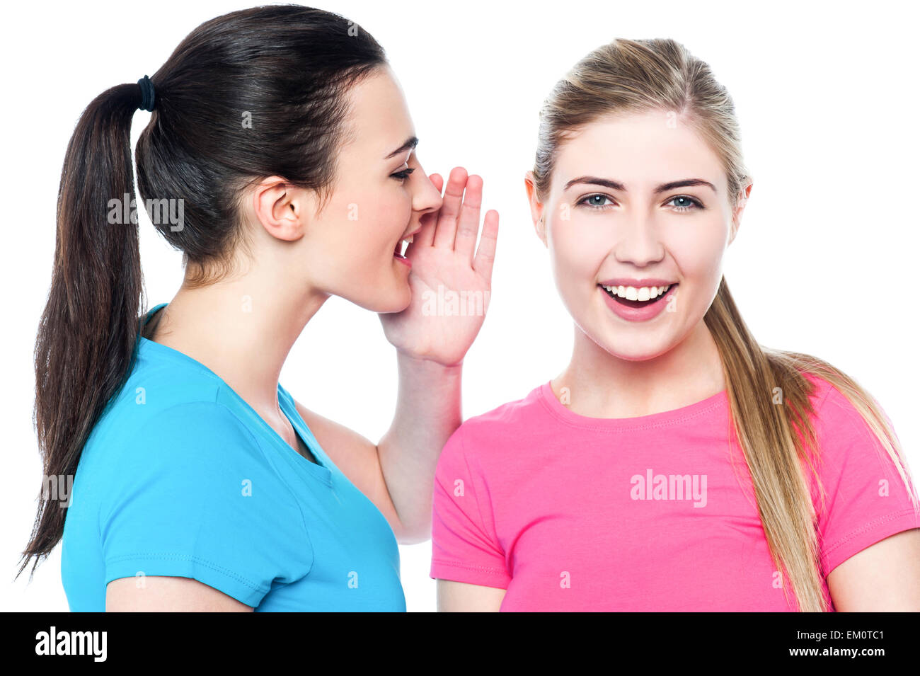 Two pretty young girls gossiping Stock Photo - Alamy