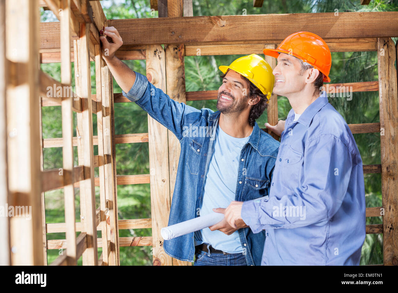 Happy Architects Discussing At Construction Site Stock Photo - Alamy
