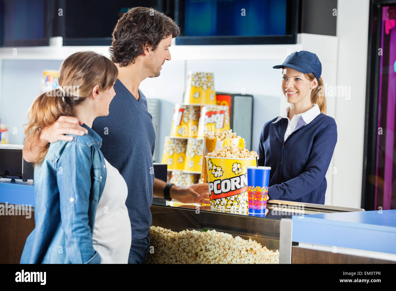 Expectant Couple Buying Popcorn At Cinema Concession Stand Stock Photo ...
