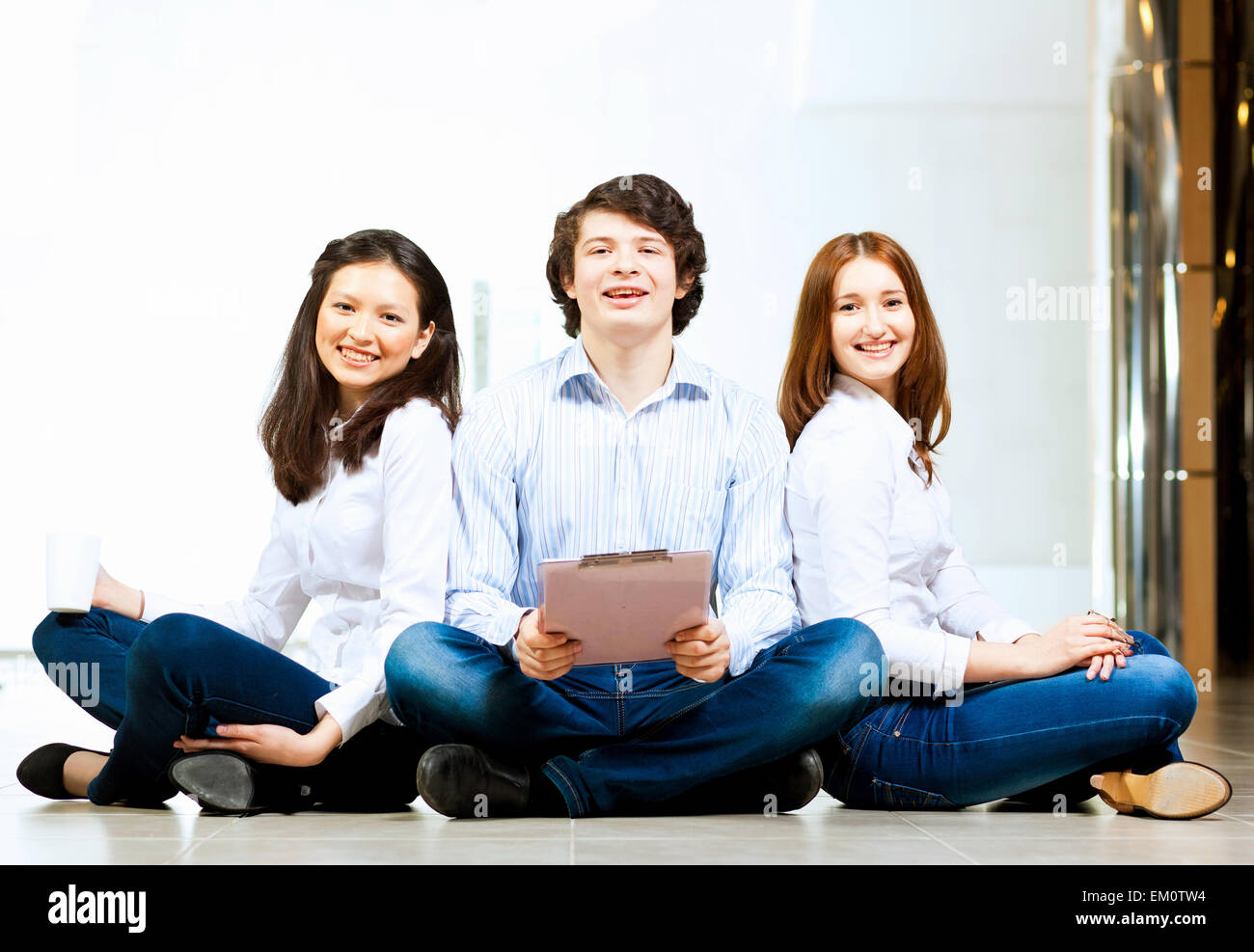 Three students smiling Stock Photo - Alamy