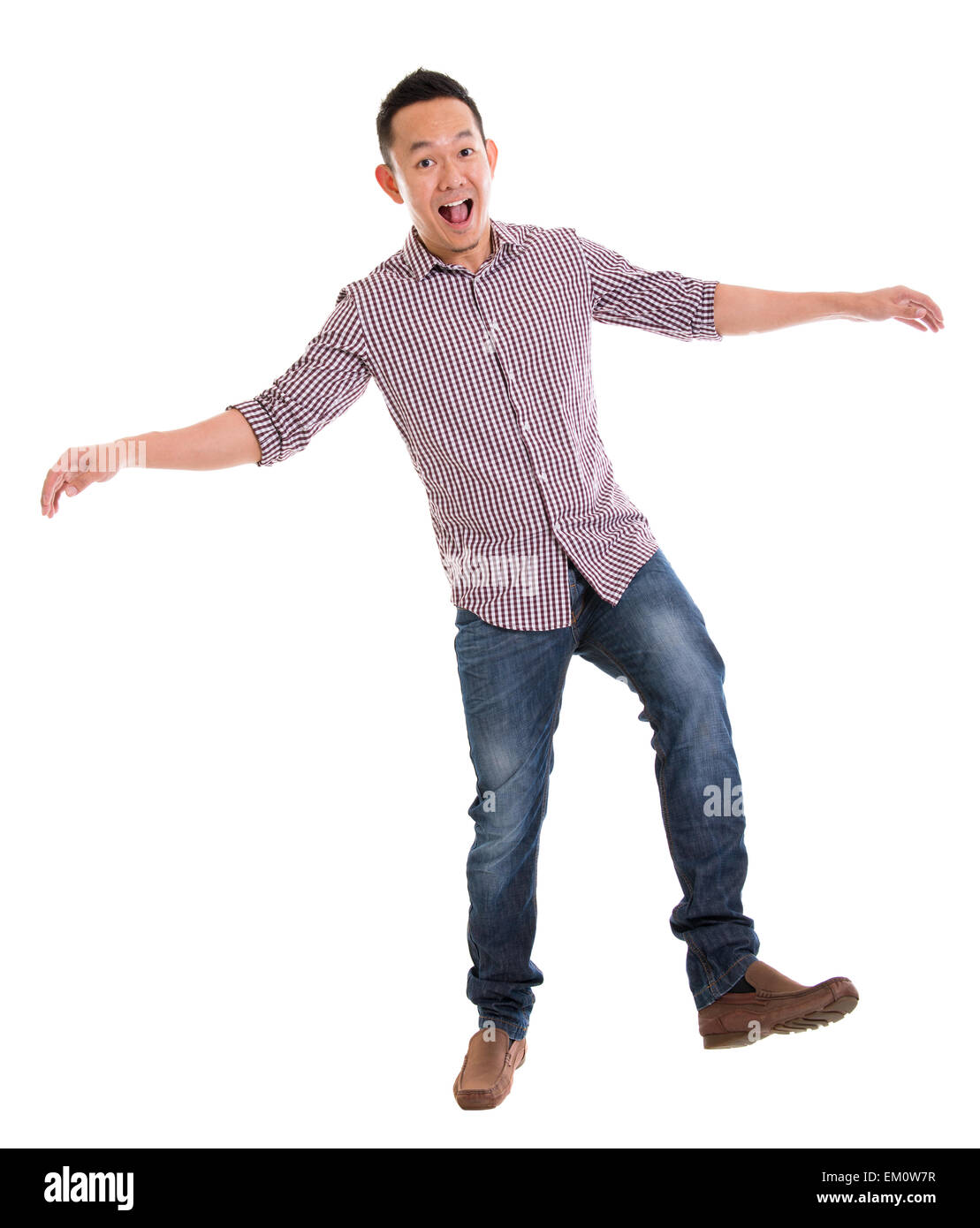 Asian man walking carefully Stock Photo - Alamy