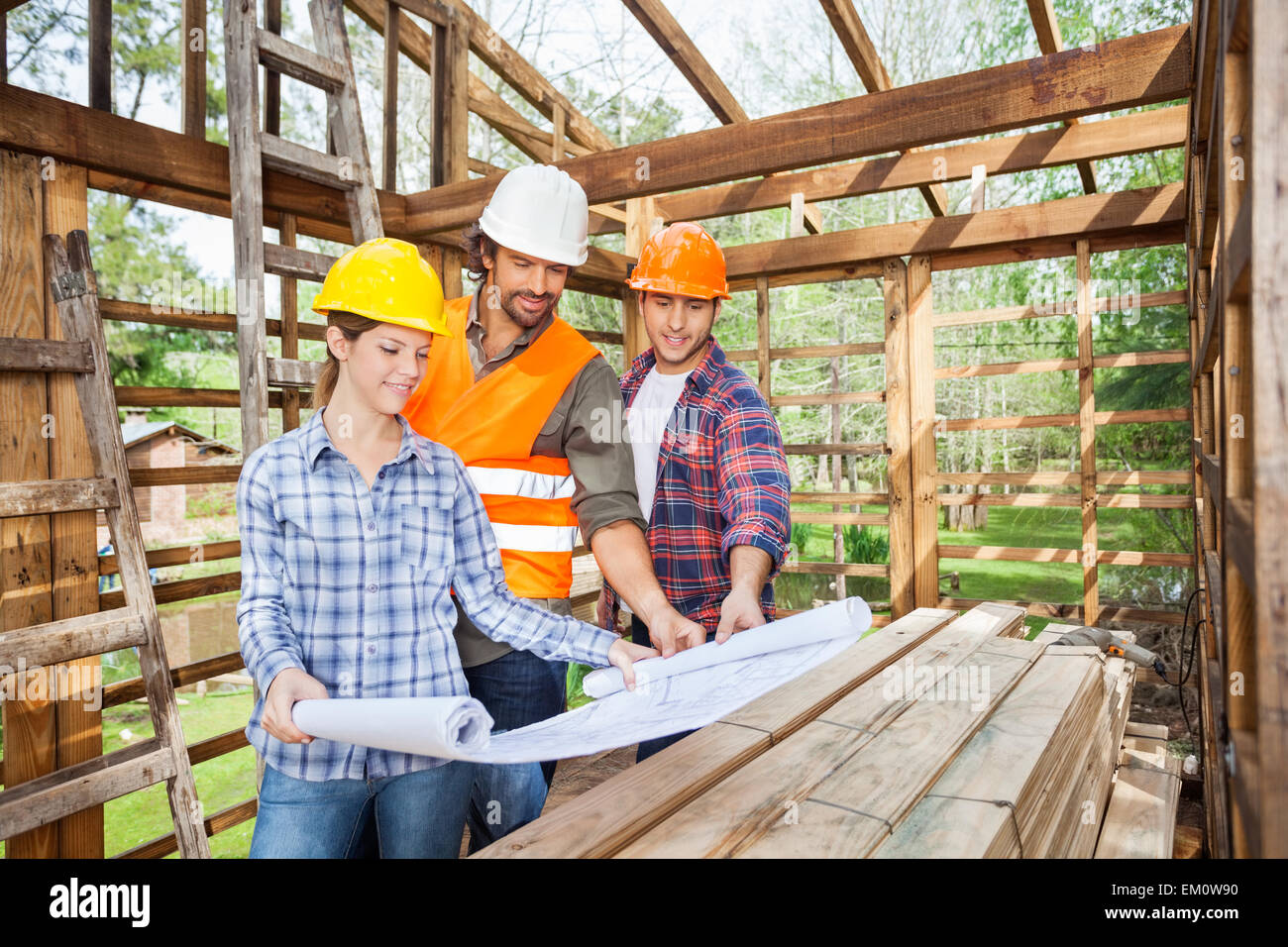 Architects Studying Blueprint At Site Stock Photo - Alamy