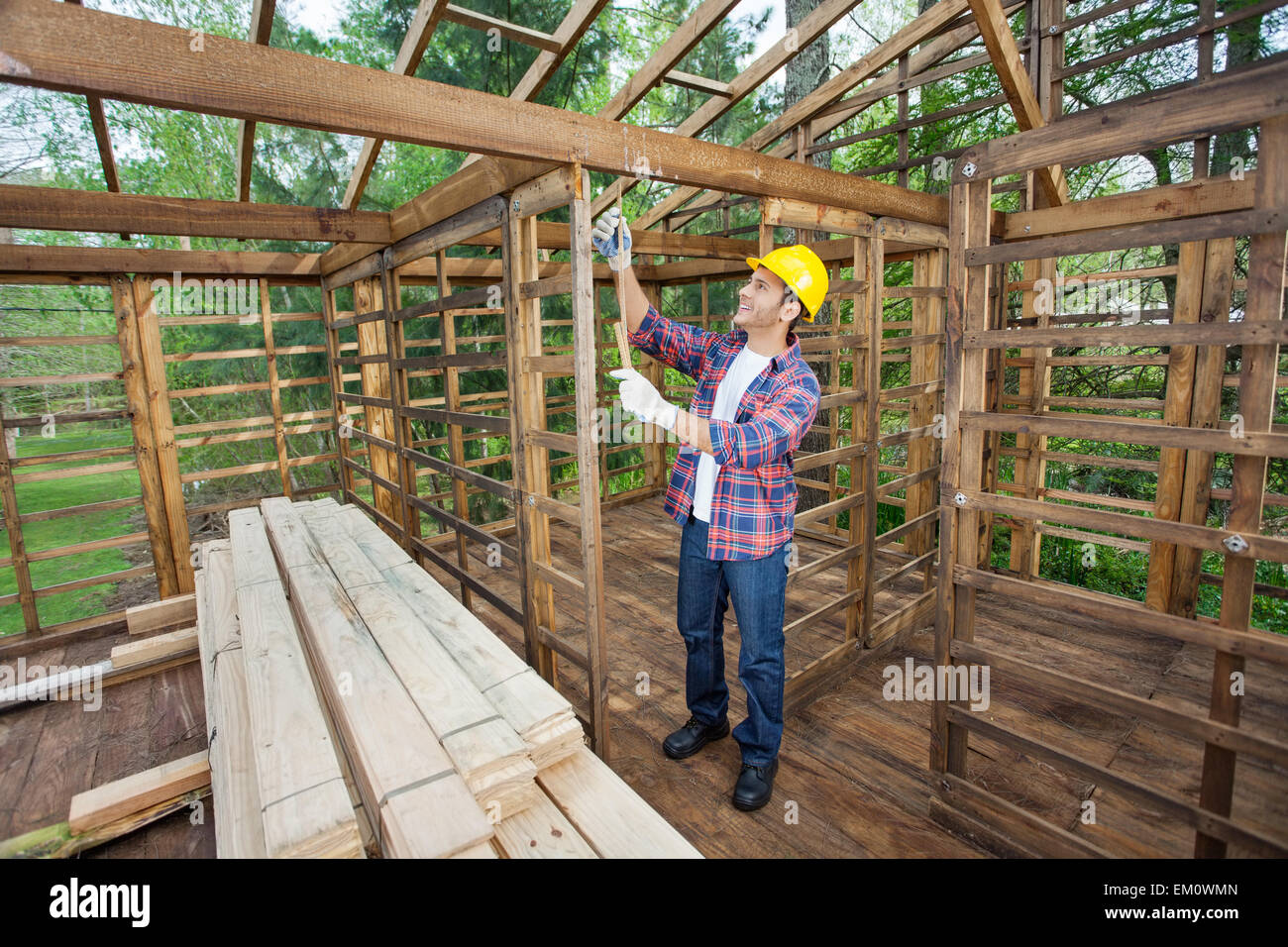 Worker Taking Measurements In Timber Cabin Stock Photo - Alamy