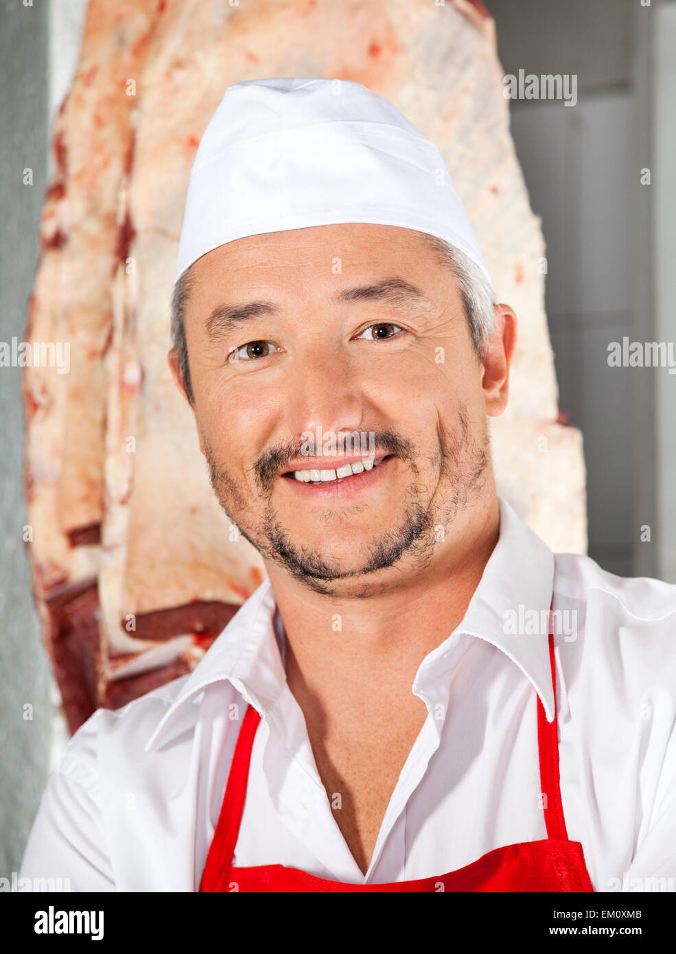Confident Butcher Smiling In Butchery Stock Photo - Alamy