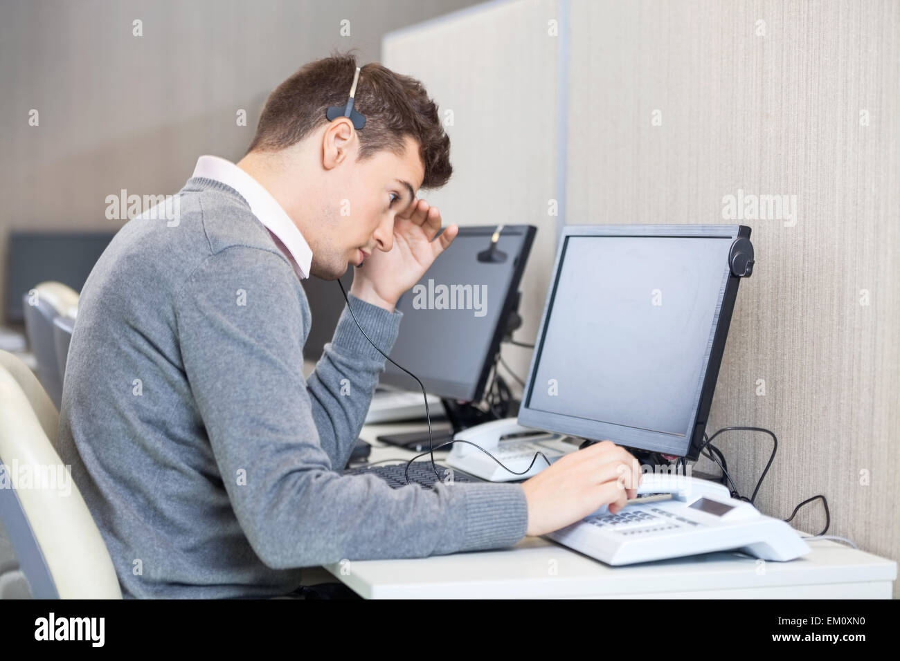 Tensed Customer Service Representative At Desk Stock Photo - Alamy