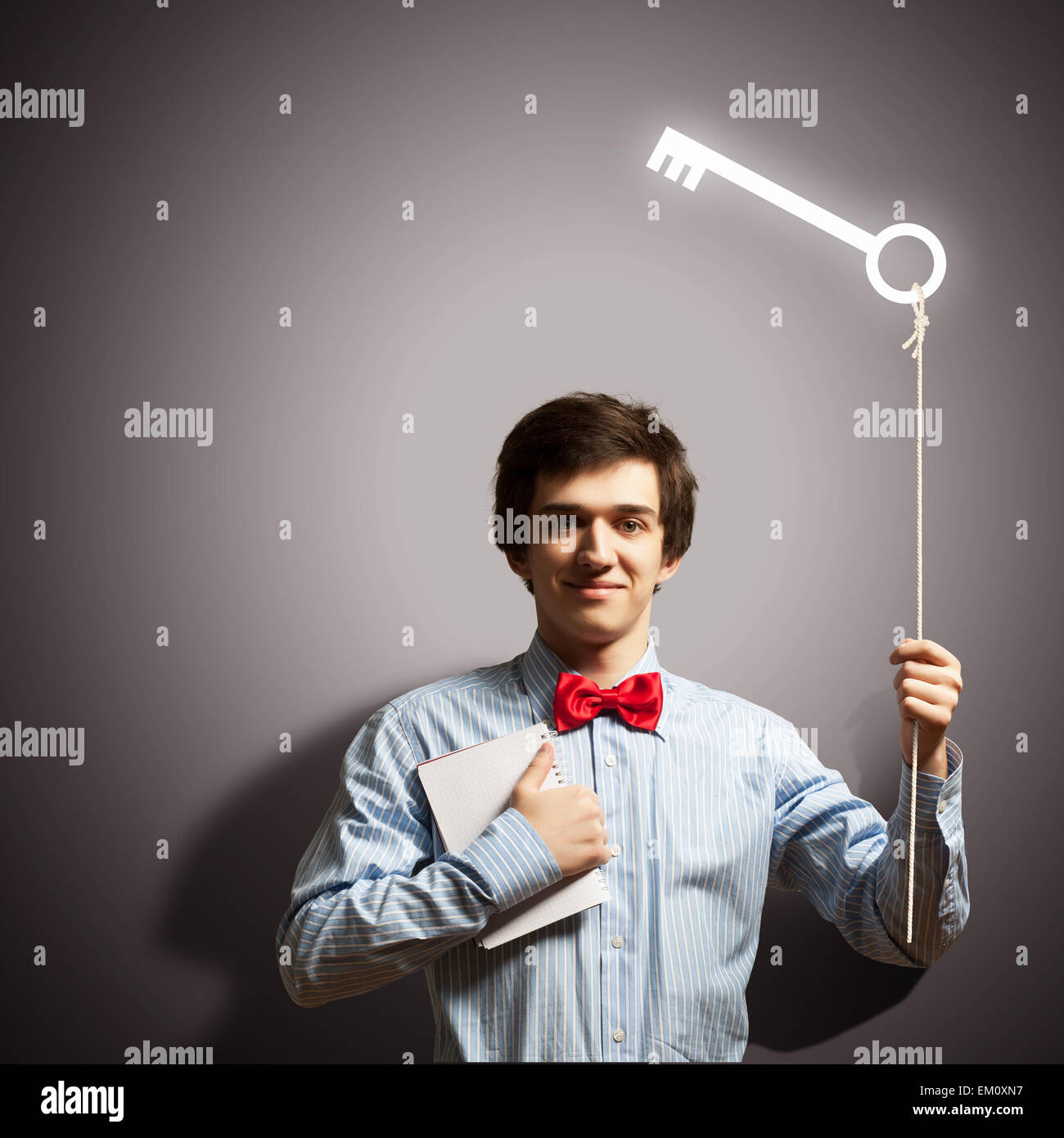 Young businessman holding key Stock Photo - Alamy
