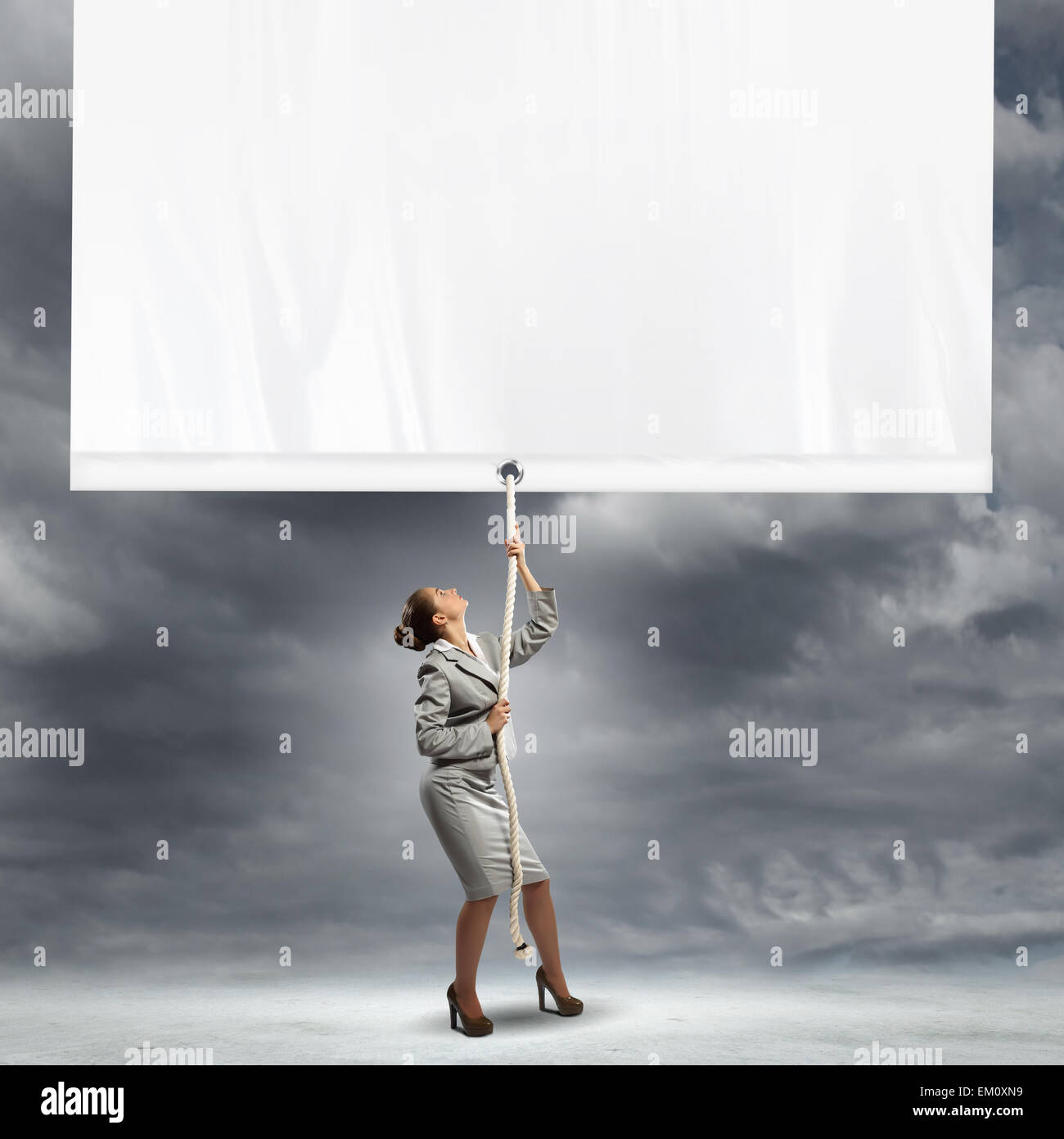 Businesswoman pulling blank banner Stock Photo - Alamy