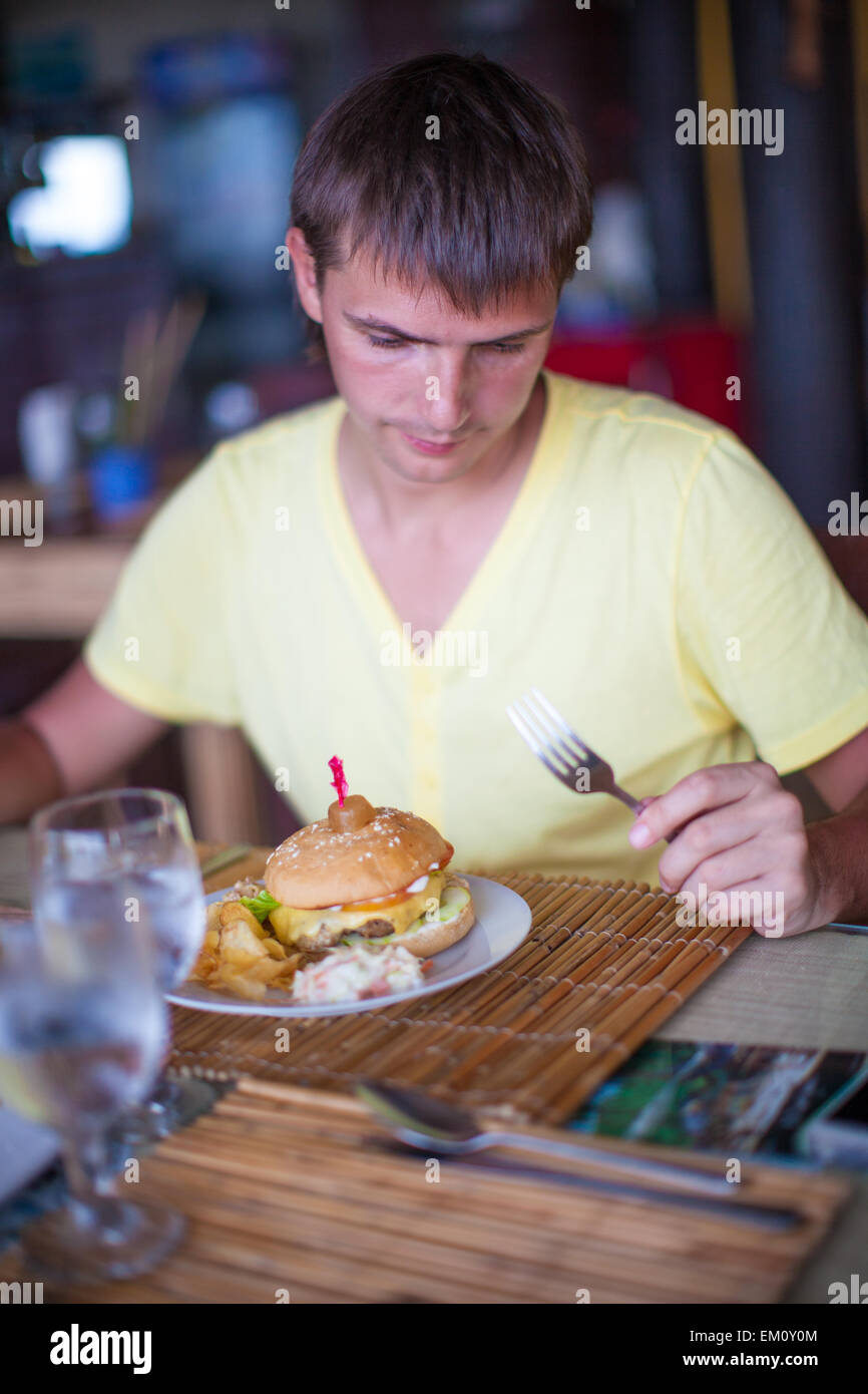 Portrait of young man having breakfast in exotic resort Stock Photo - Alamy