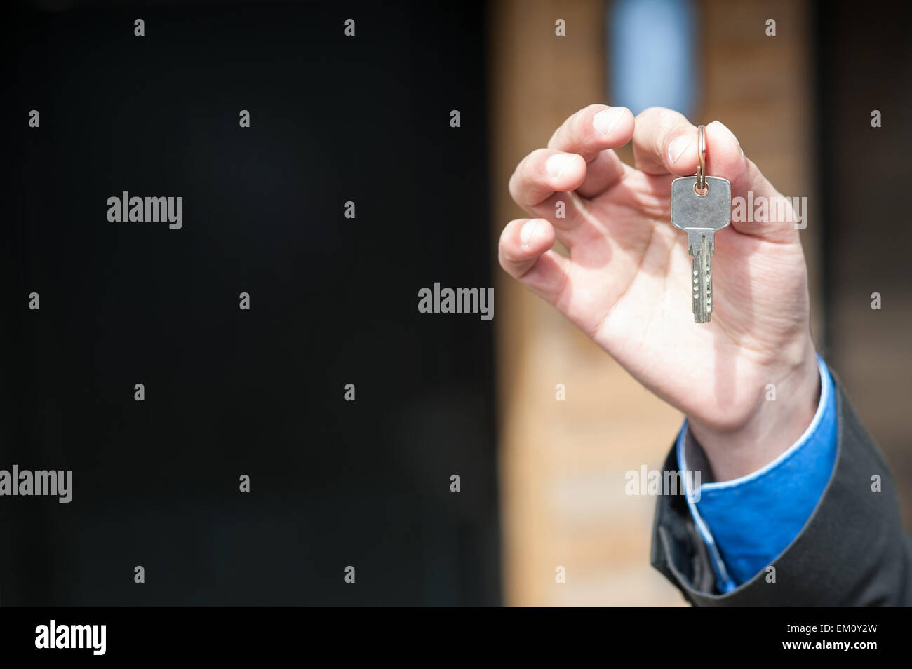 Human hand holding key Stock Photo - Alamy