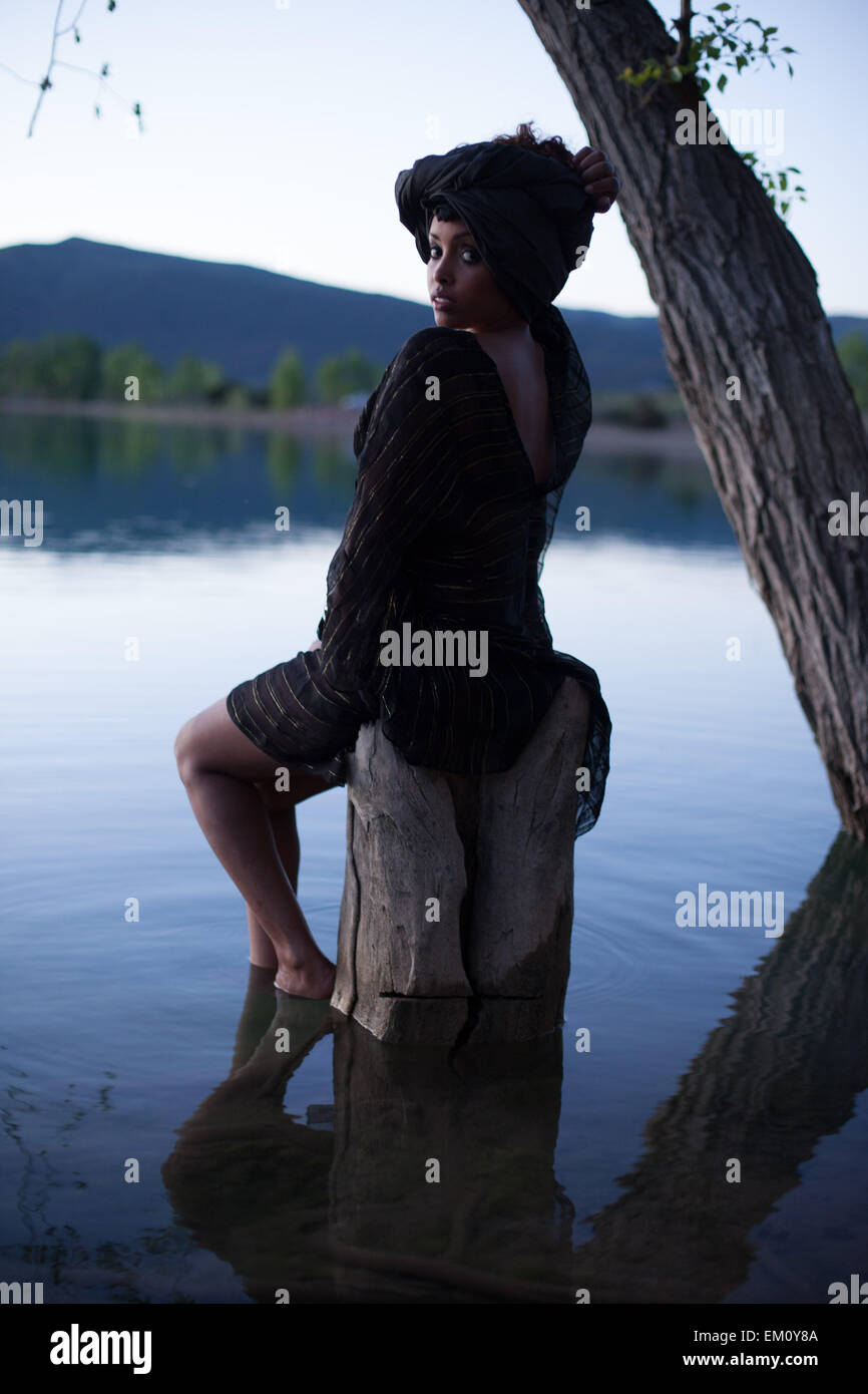 Beautiful woman wading in water Stock Photo - Alamy
