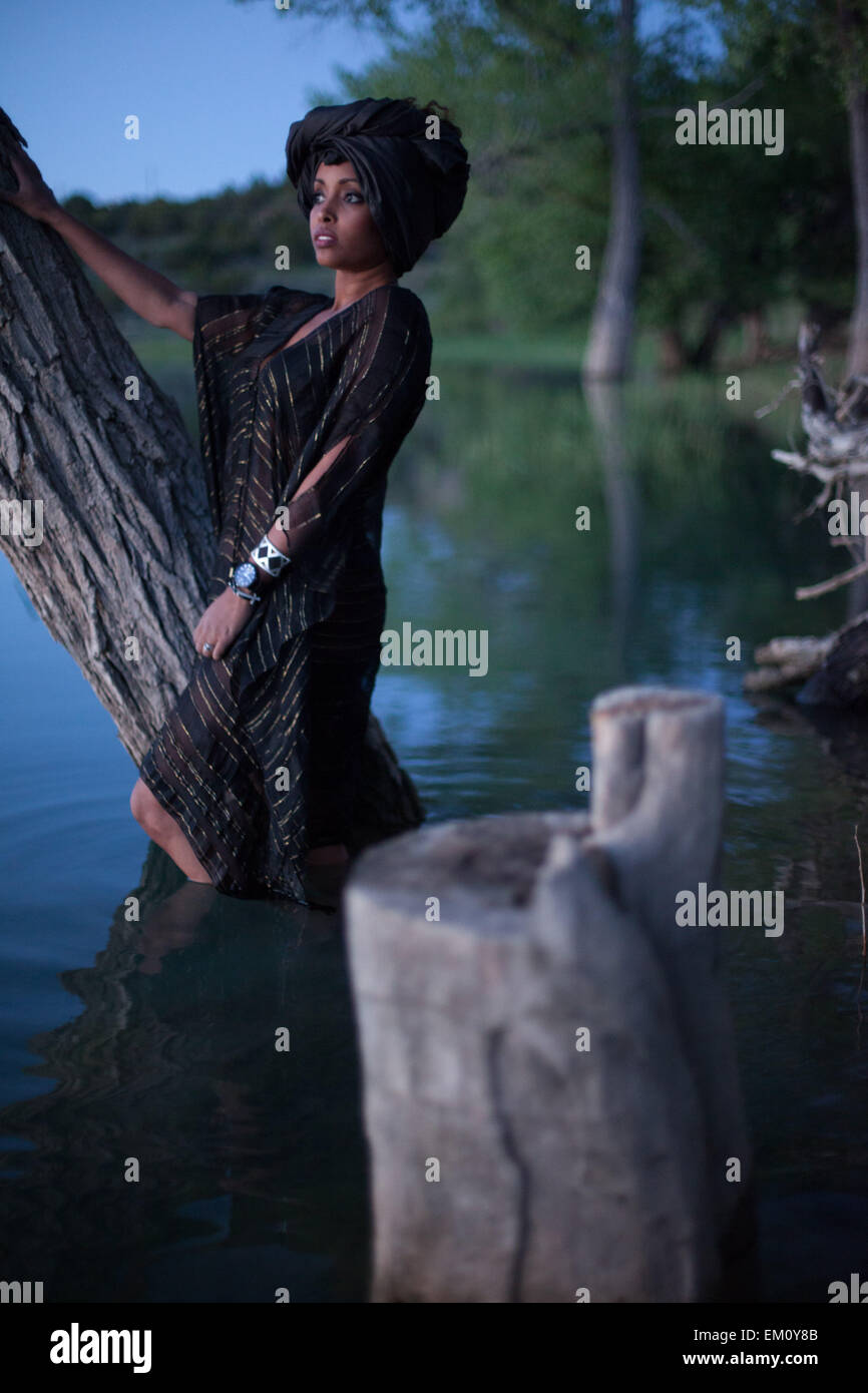 Beautiful woman wading in water Stock Photo - Alamy
