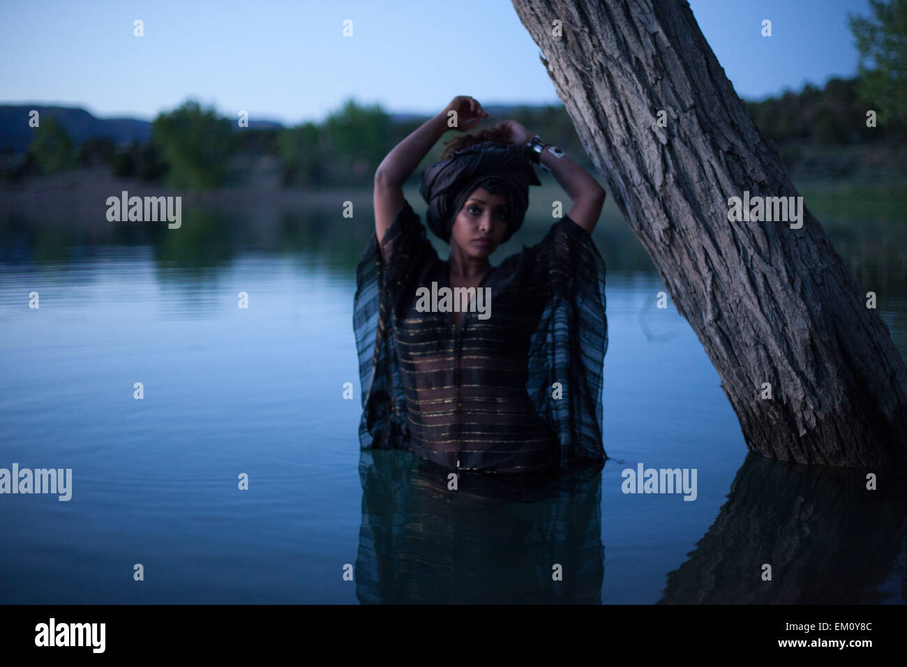 Beautiful woman wading in water Stock Photo - Alamy