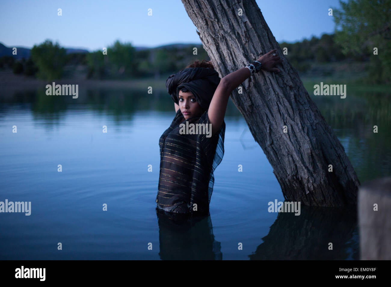 Beautiful woman wading in water Stock Photo - Alamy