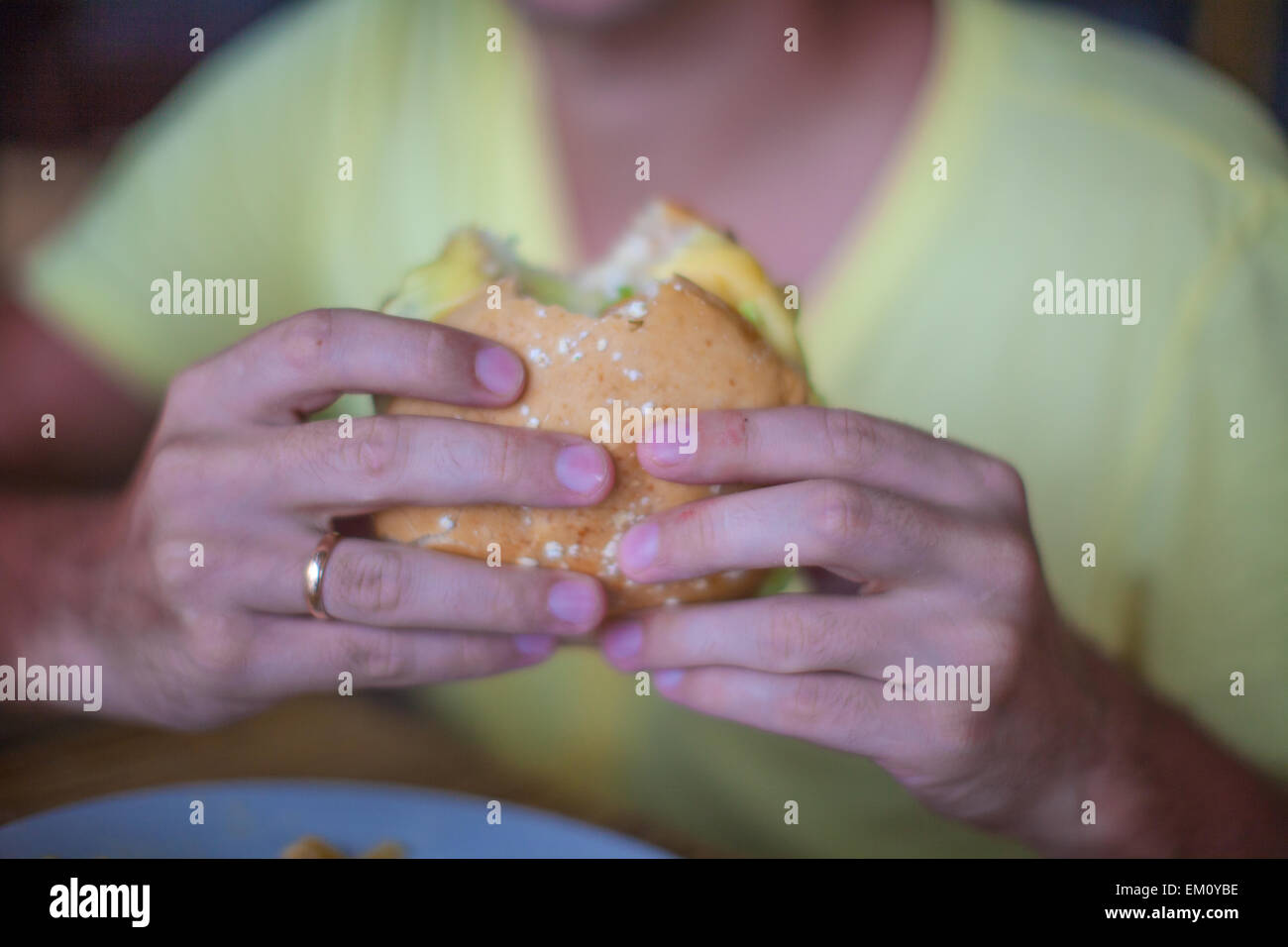 Close up burger in man's hands on the breakfast Stock Photo - Alamy