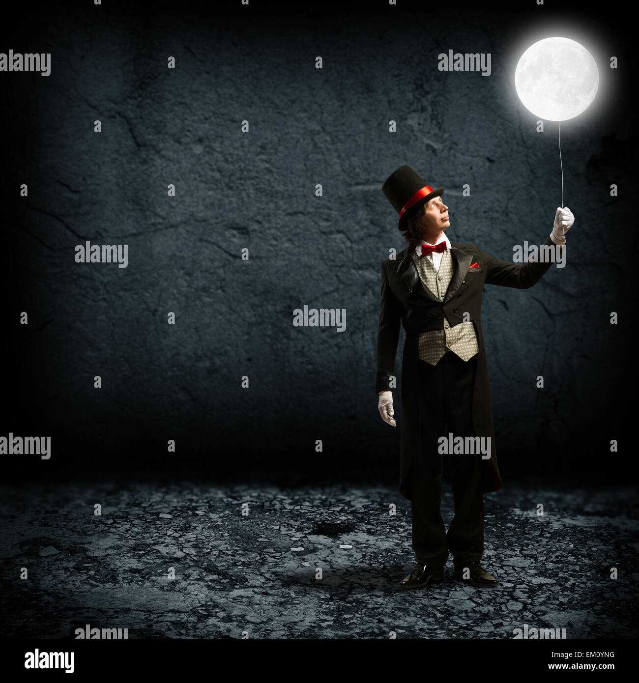 magician keeps the moon on a string Stock Photo - Alamy