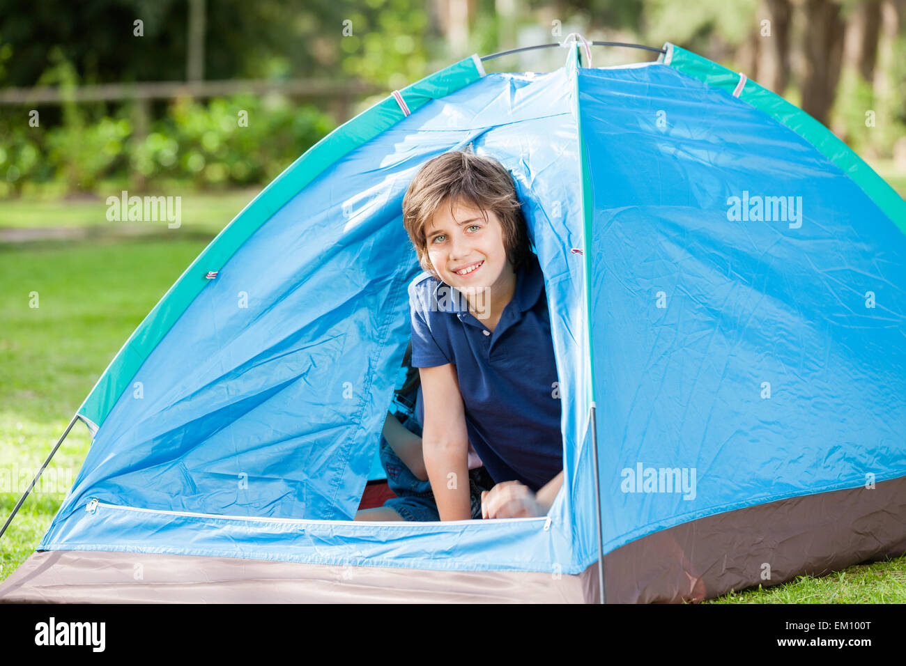 Boy Sitting In Tent Stock Photo - Alamy