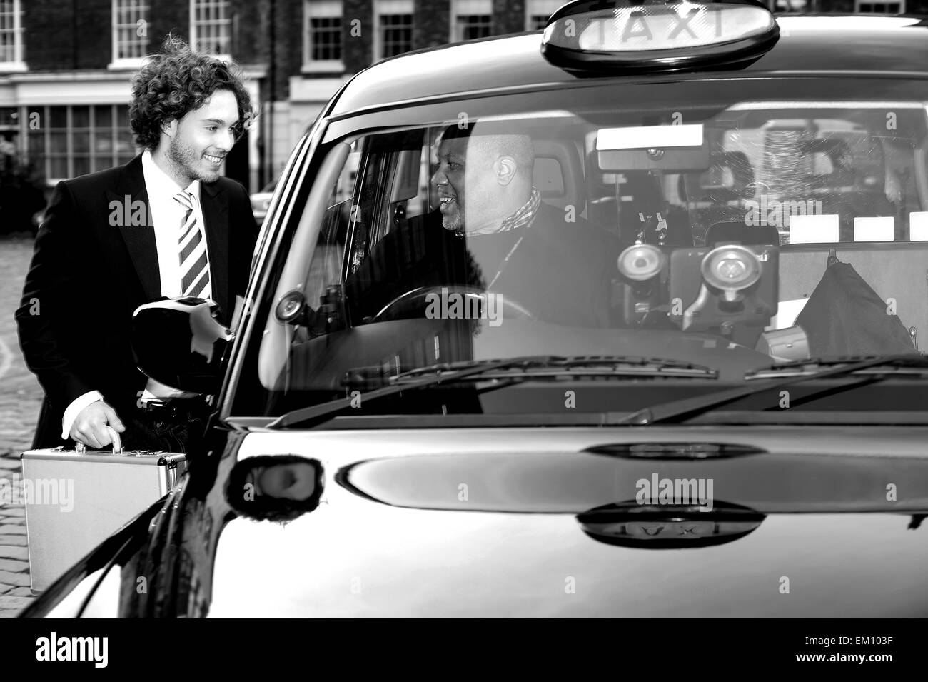 Male passenger communicating with taxi driver Stock Photo - Alamy