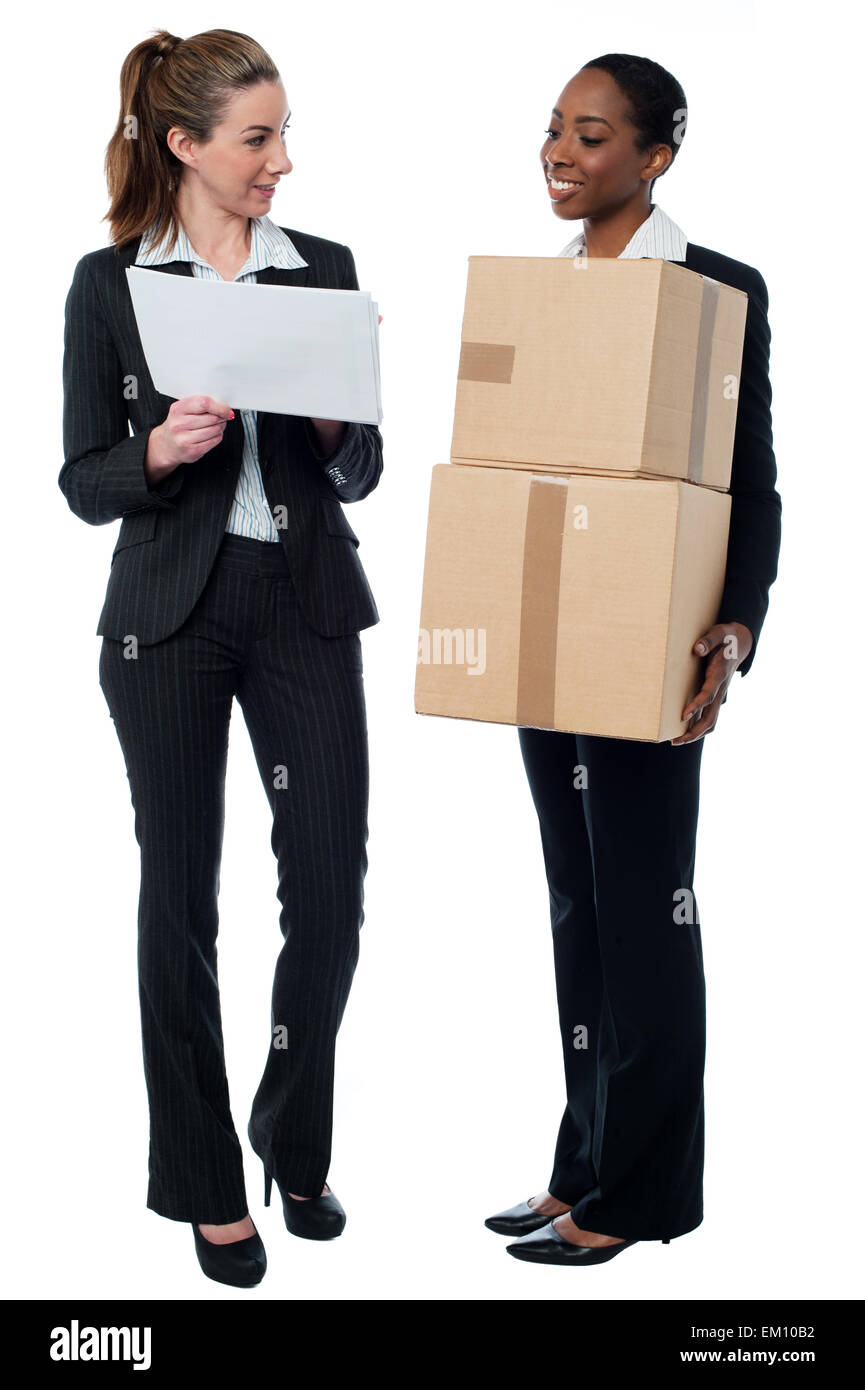 Two female workers discussing stock details Stock Photo - Alamy