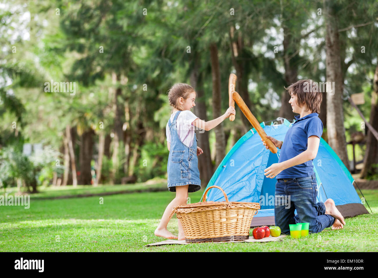 Siblings Fighting With Bread Loafs In Park Stock Photo - Alamy