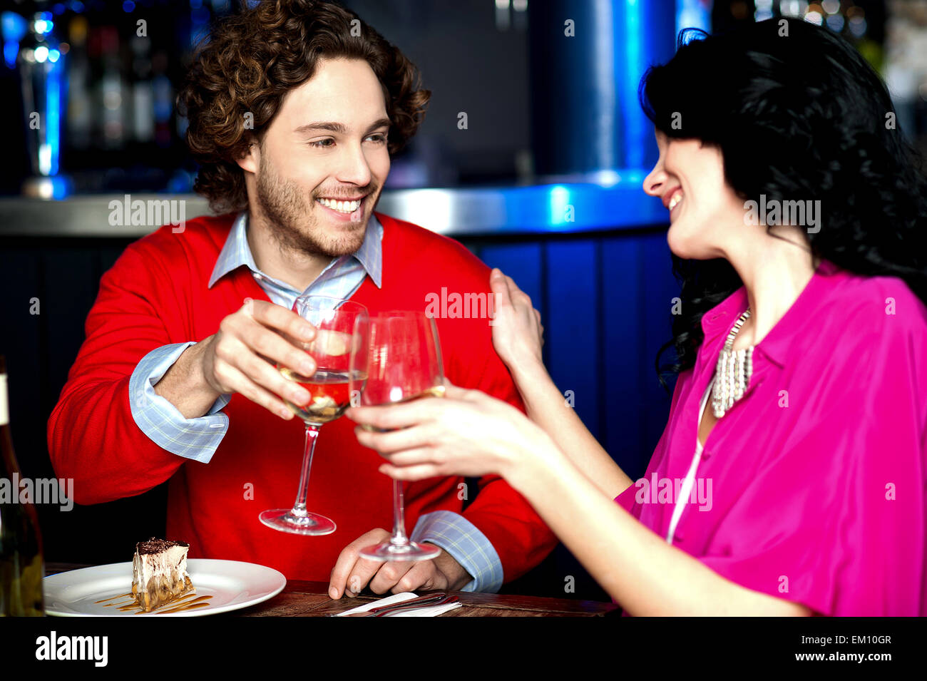 Cheers! Couple celebrating their love together Stock Photo - Alamy