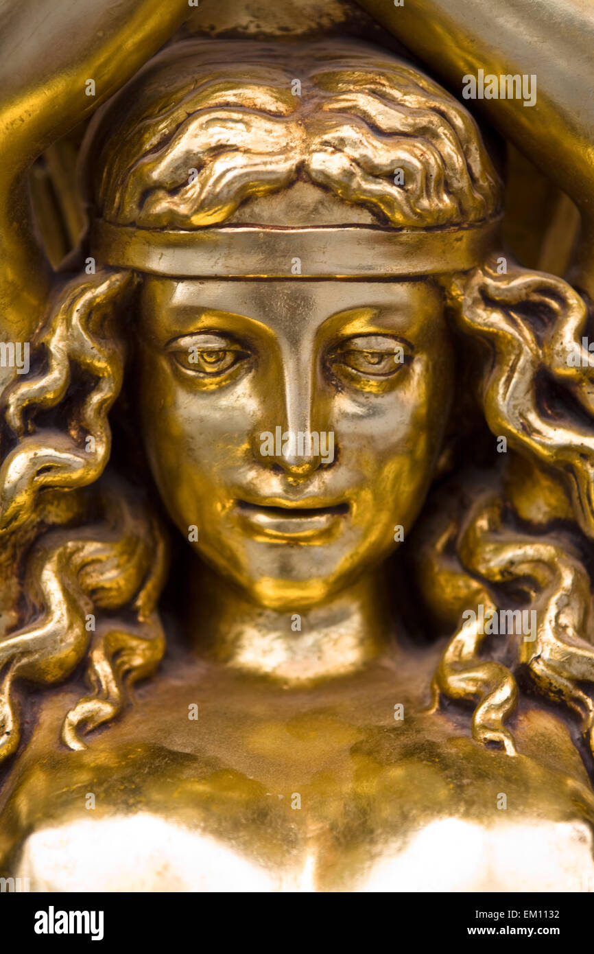 Golden bust head of a Greek maiden flanking the entry of a classic ...
