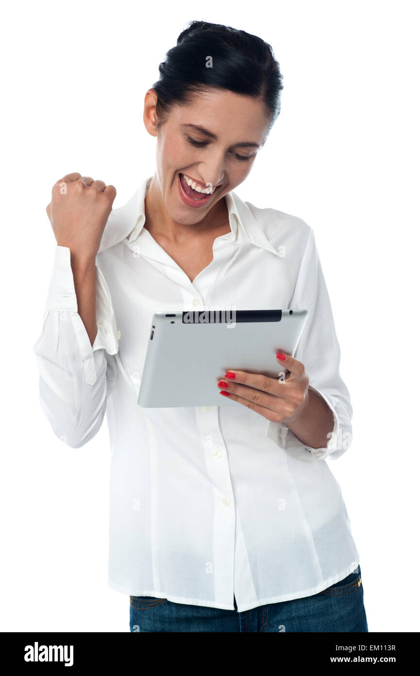 Excited pretty woman using tablet pc Stock Photo - Alamy