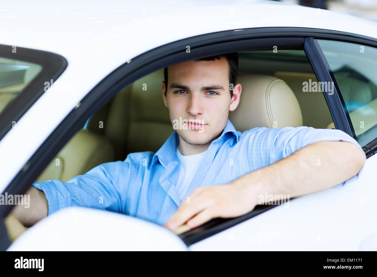 Young man sitting in car Stock Photo - Alamy