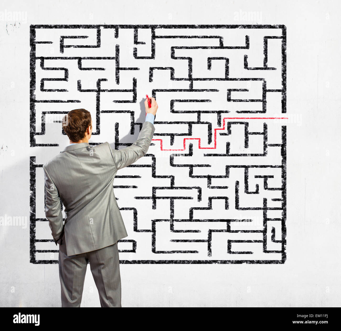 Businessman solving labyrinth problem Stock Photo - Alamy