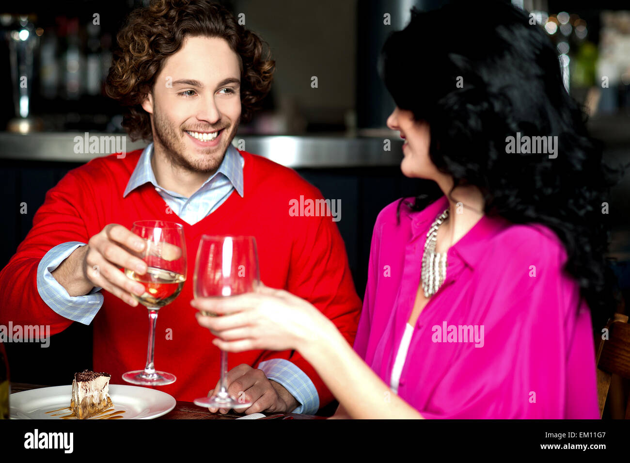 Cheers! Couple celebrating their love together Stock Photo - Alamy