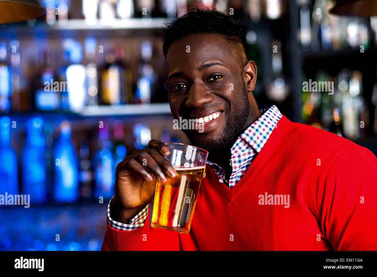 Guy drinking beer in a nightclub Stock Photo - Alamy