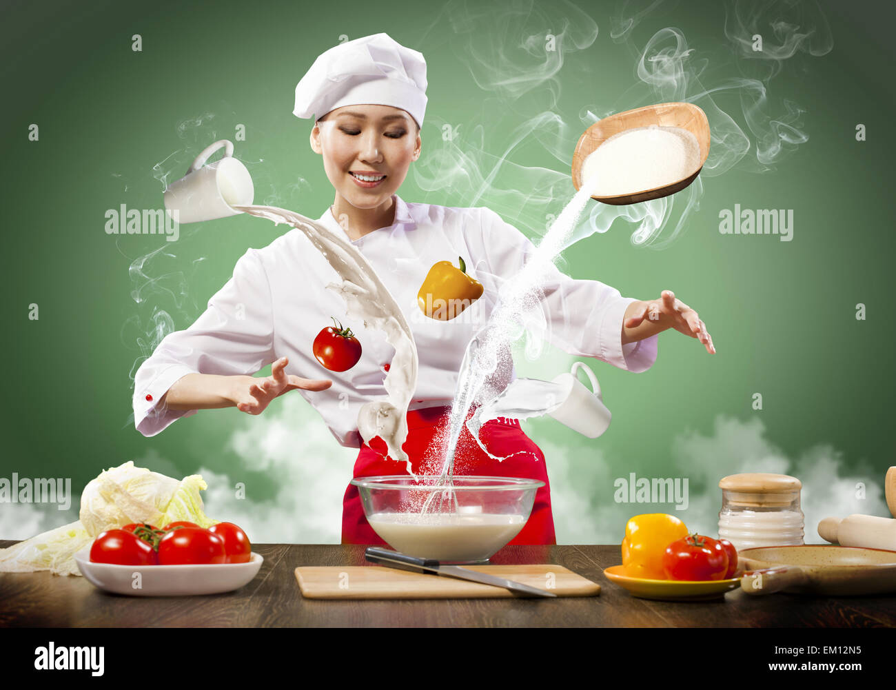 Asian female cooking with magic Stock Photo - Alamy
